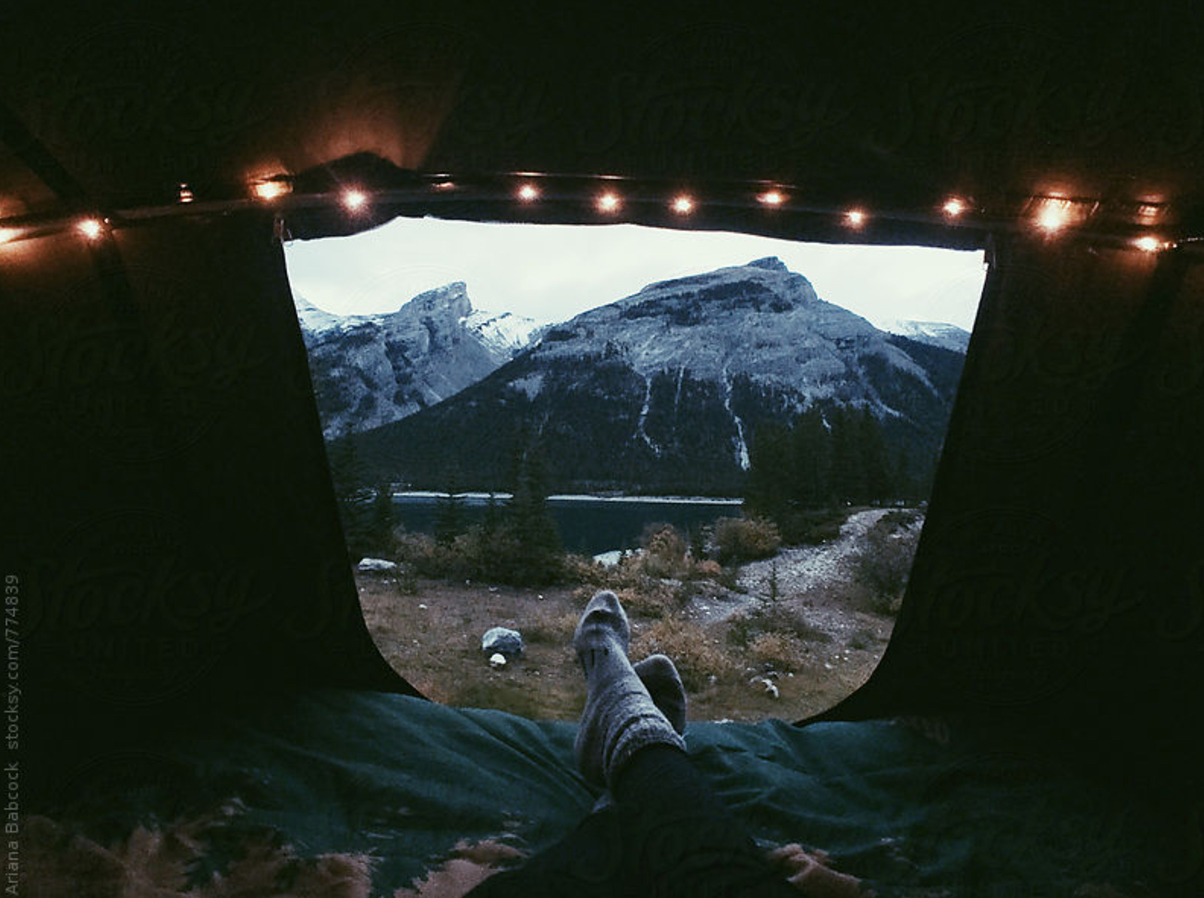 Tents at the shore of Lake Saiful Muluk and star trails in the sky in ...